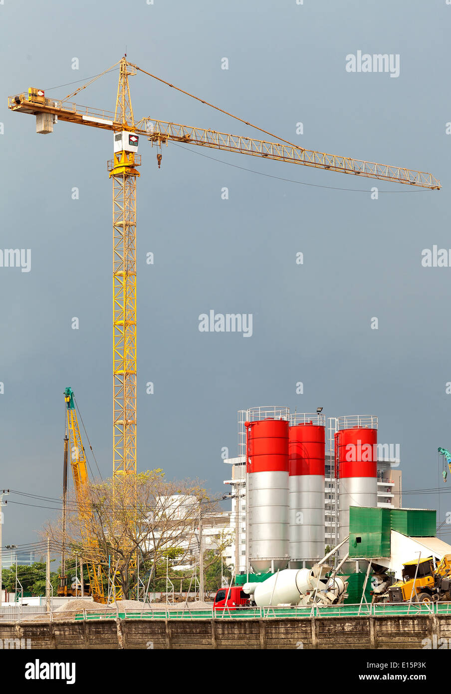 Crane and cement tower equipment in construction site Stock Photo - Alamy