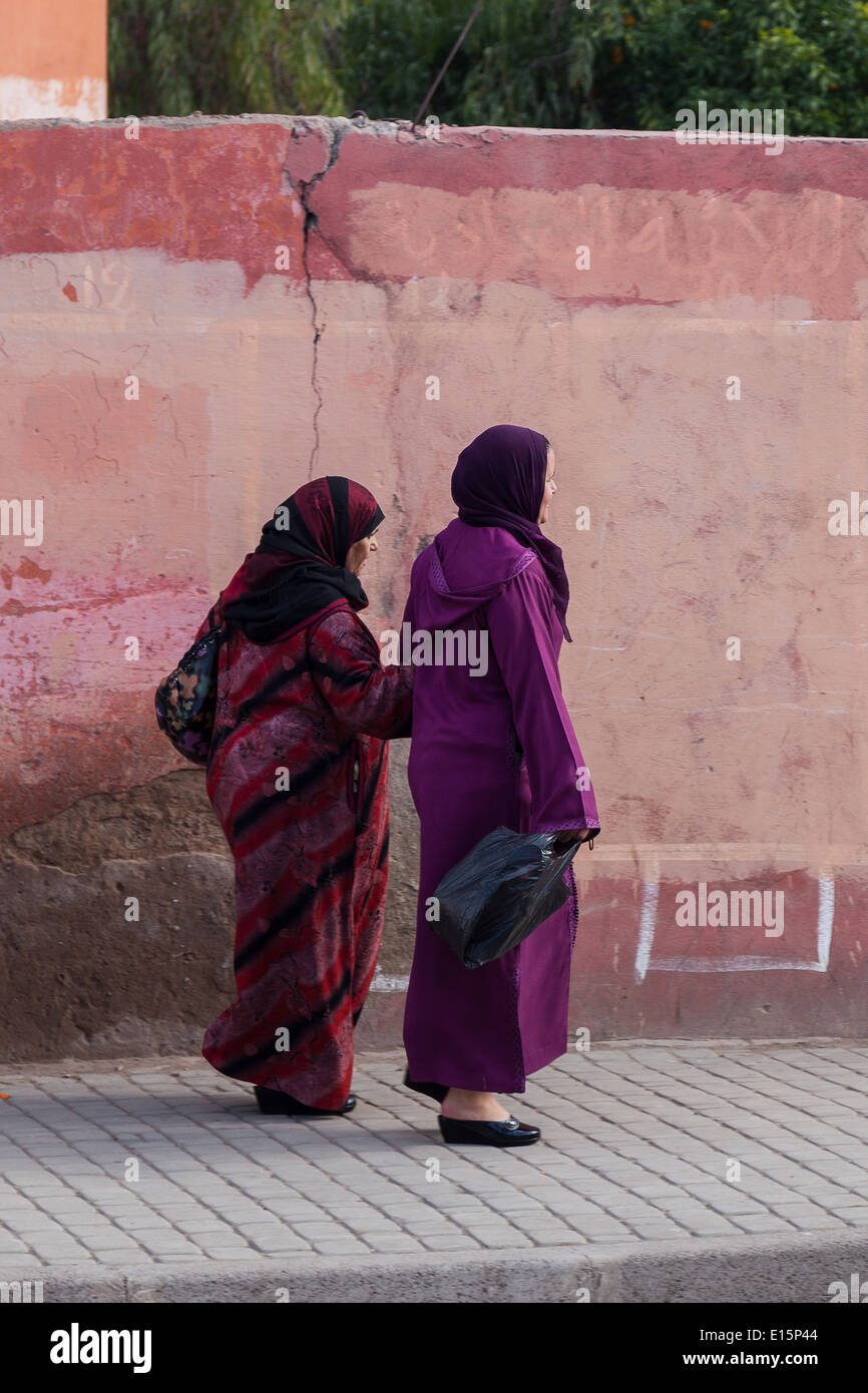 two women in traditional Arab robes in Marrakech, Morocco Stock Photo ...