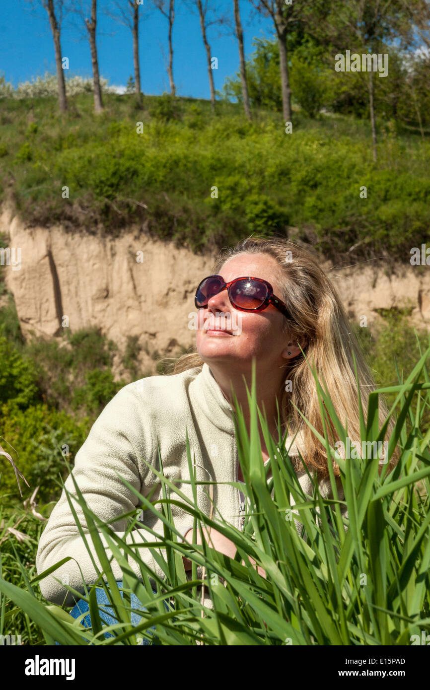 Woman basking in the sun hi-res stock photography and images - Alamy