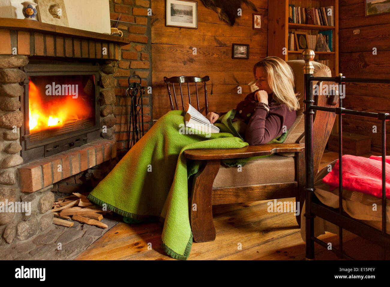 Woman reading a book in front of chimney Stock Photo - Alamy