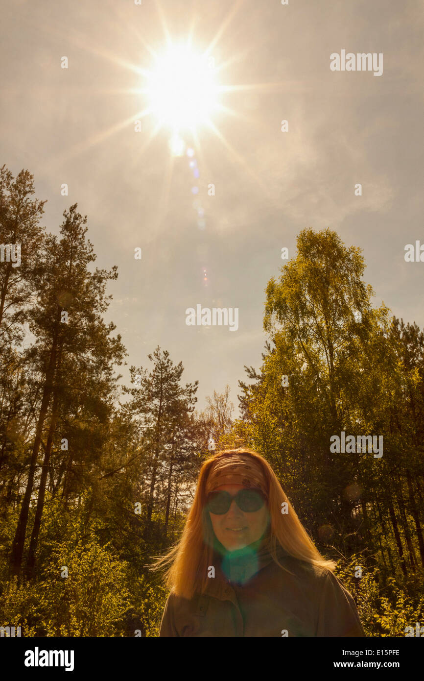 Portrait of a woman against the sun Stock Photo - Alamy
