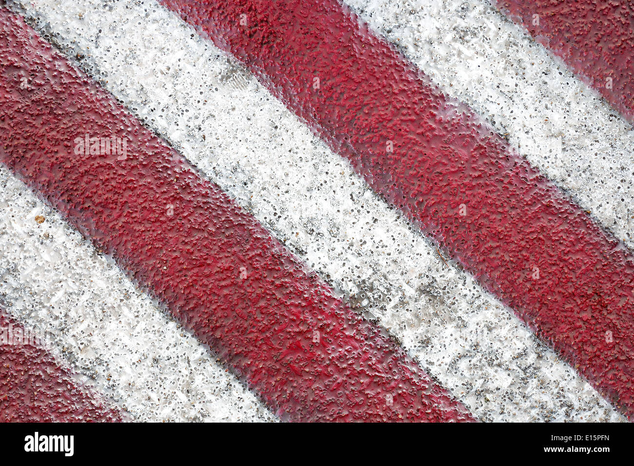 Warning stripes in red and white on road texture Stock Photo - Alamy