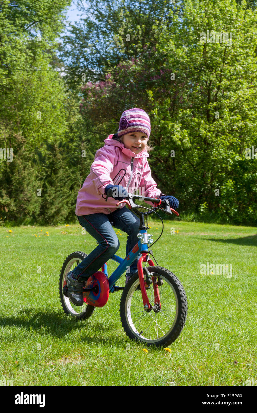 Preschool girl riding her bicycle Stock Photo - Alamy