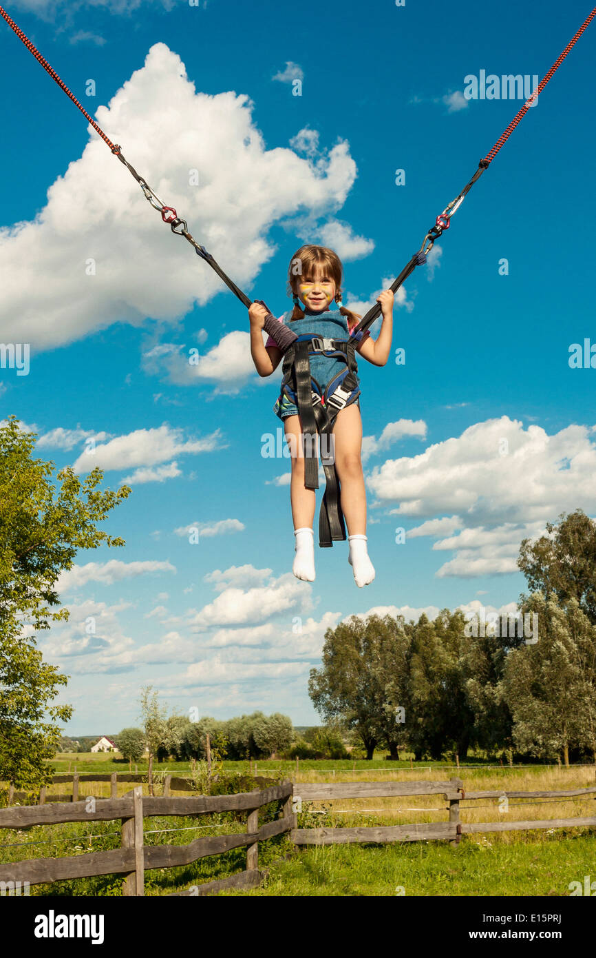 Happy girl jumping on a trampoline Stock Photo - Alamy