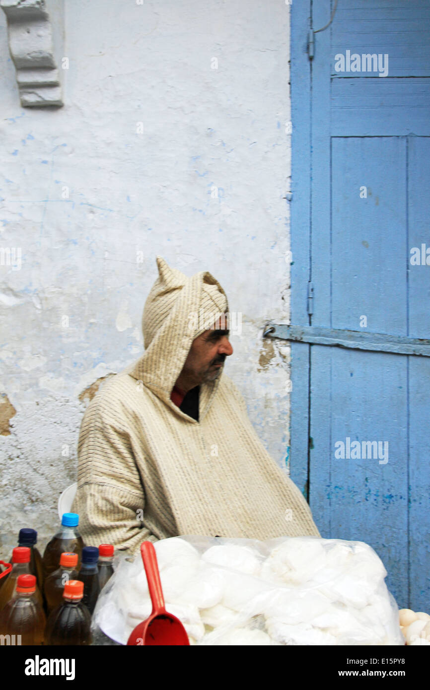 Traditional Moroccan man wearing a Djellaba walking in the town of ...