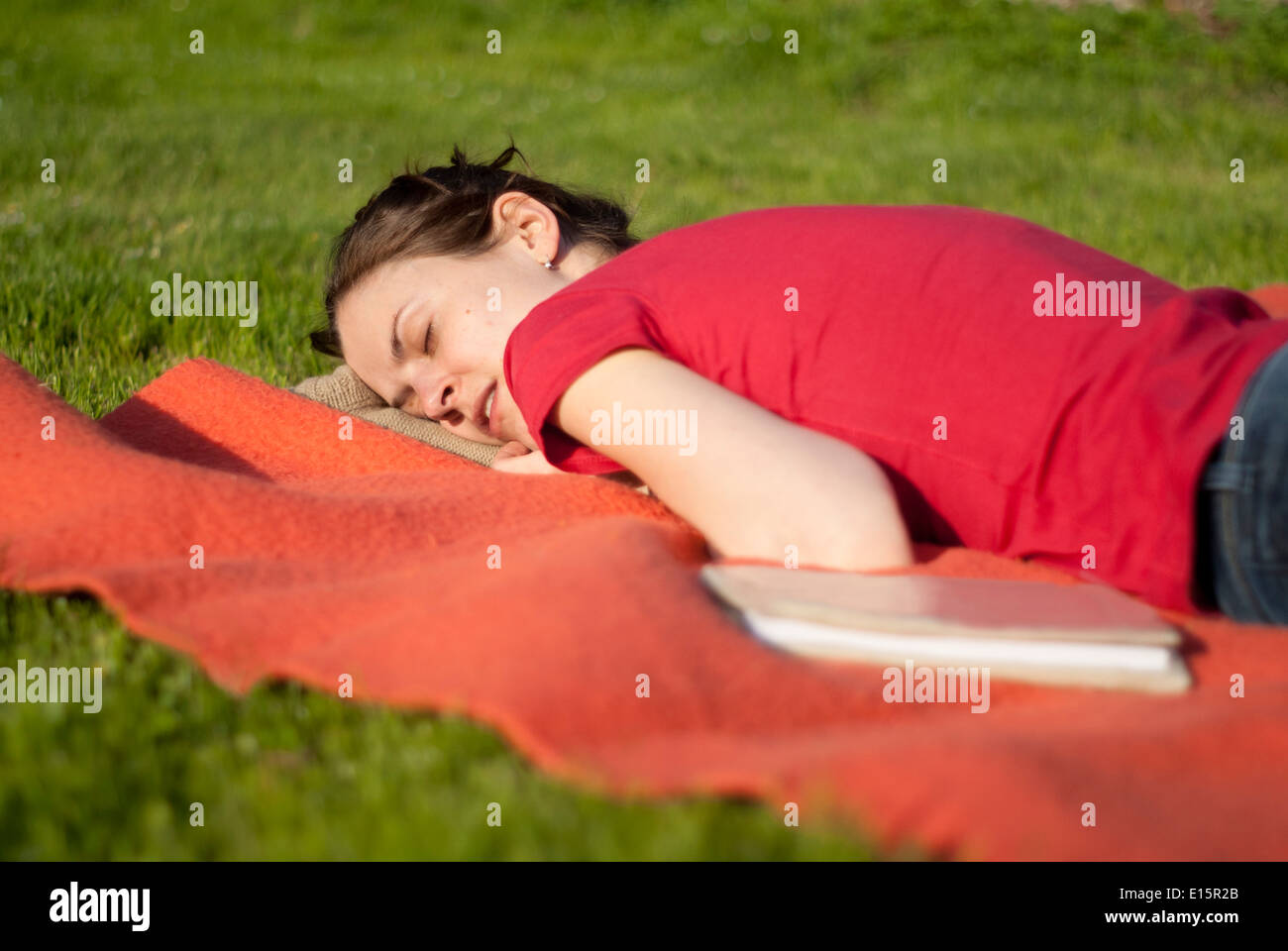 Woman taking nap on grass hi-res stock photography and images - Alamy
