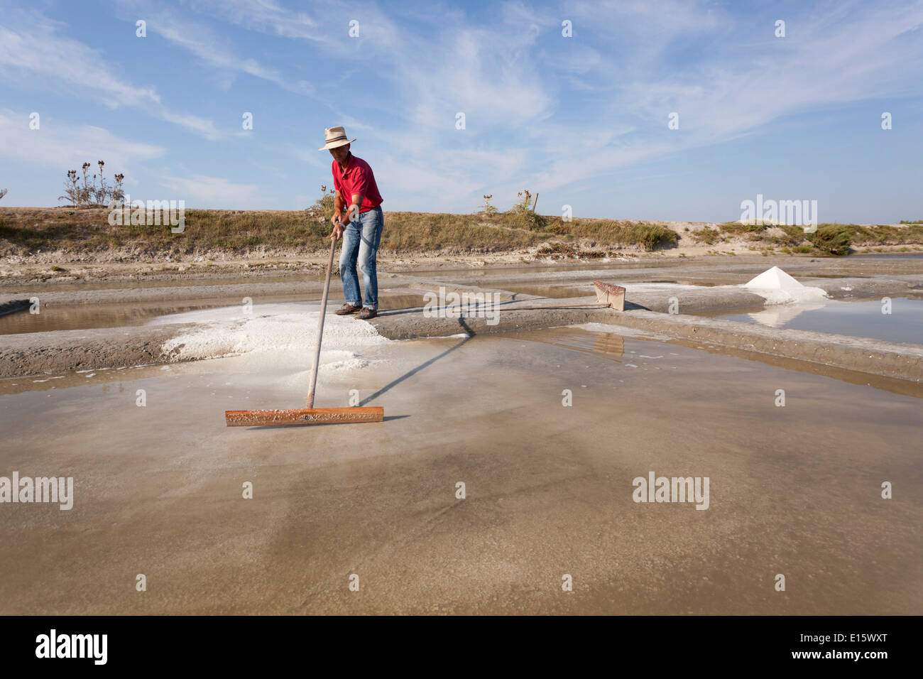 Salt-marsh worker collecting salt Stock Photo - Alamy