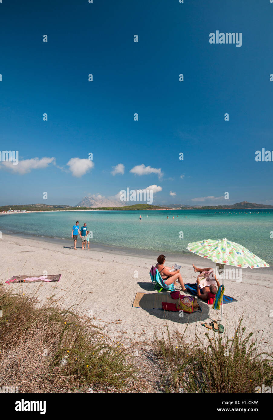 Transparent clear waters and tourists at leisure at Lu Impostu beach ...