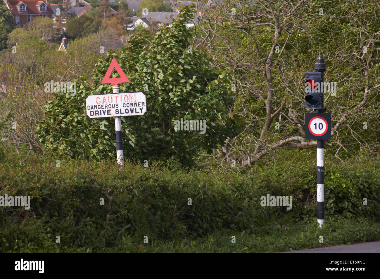 Caution dangerous corner drive slowly and 10 speed limit road signs ...