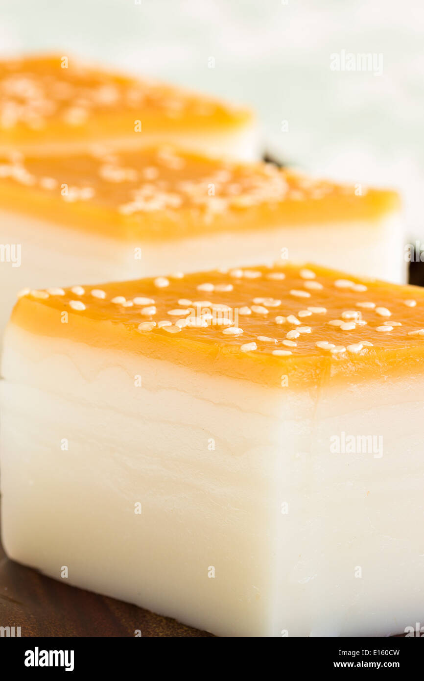 Layered Chinese rice cakes with sesame seed topping Stock Photo - Alamy