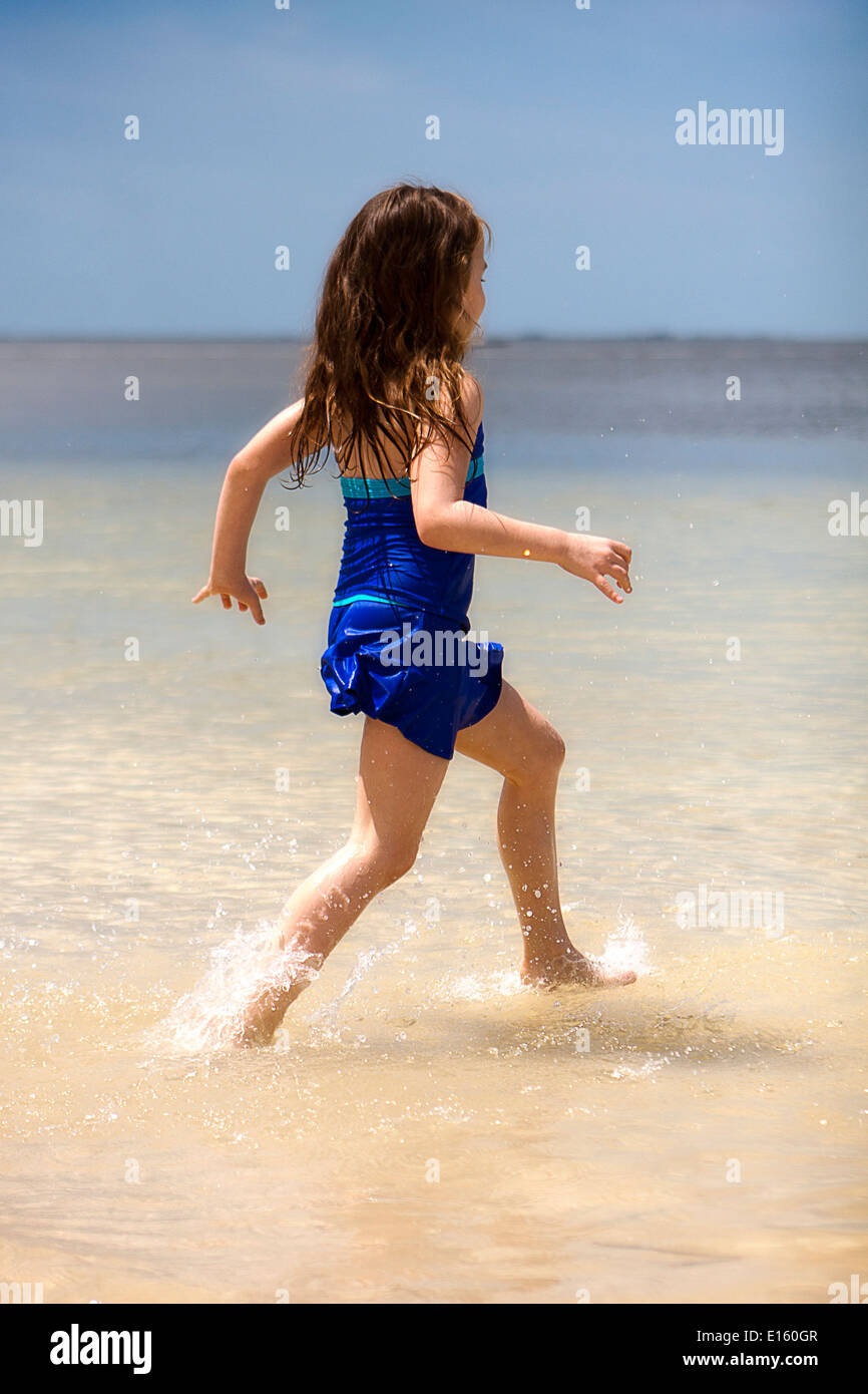 Young girl running in water Stock Photo - Alamy