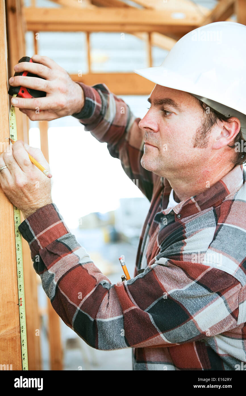Construction worker taking measurements on the job site Stock Photo - Alamy