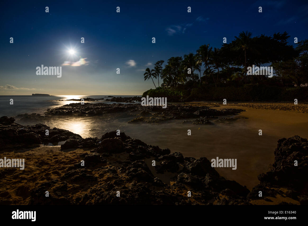 The Moon glowing over Secret Beach in Maui Stock Photo - Alamy