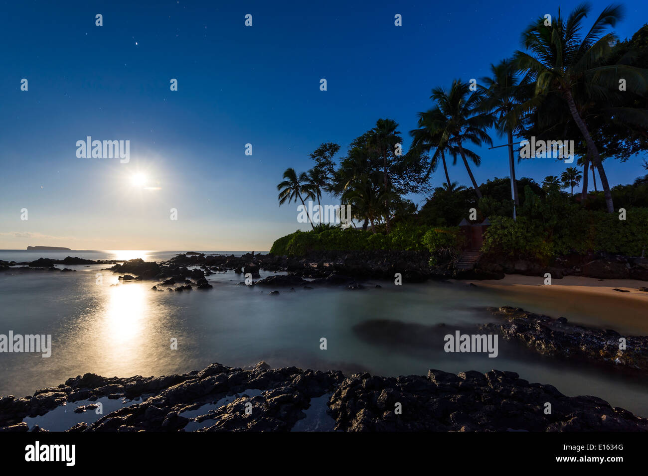 The Moon glowing over Secret Beach in Maui Stock Photo - Alamy
