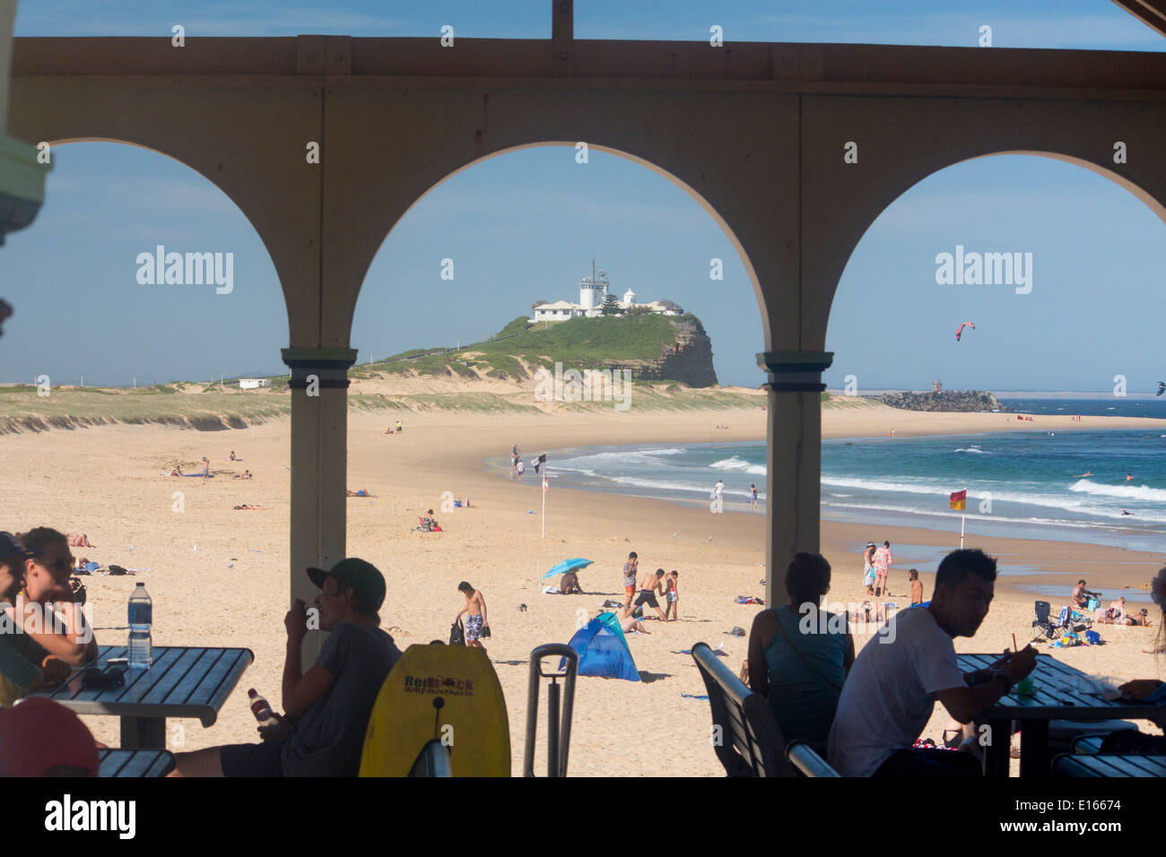 Nobbys Beach and Head seen through arches of pavilion and cafe with ...