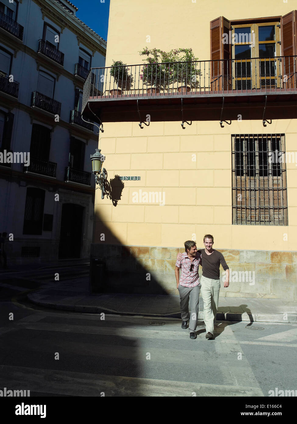 Two men crossing road Stock Photo - Alamy
