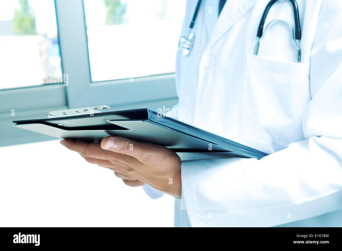 Doctor checking notes hi-res stock photography and images - Alamy