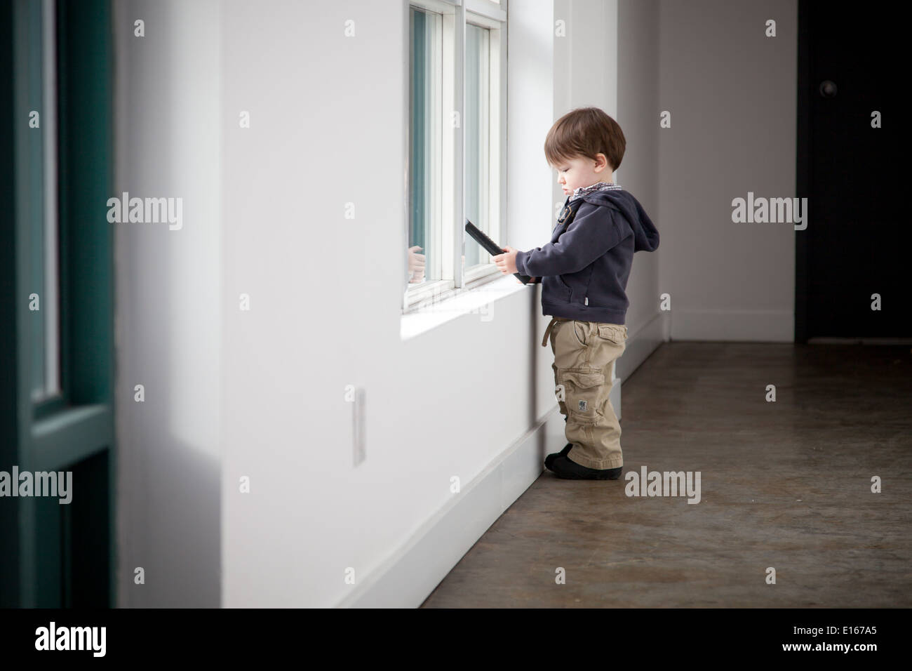 Boy playing with a remote control Stock Photo - Alamy