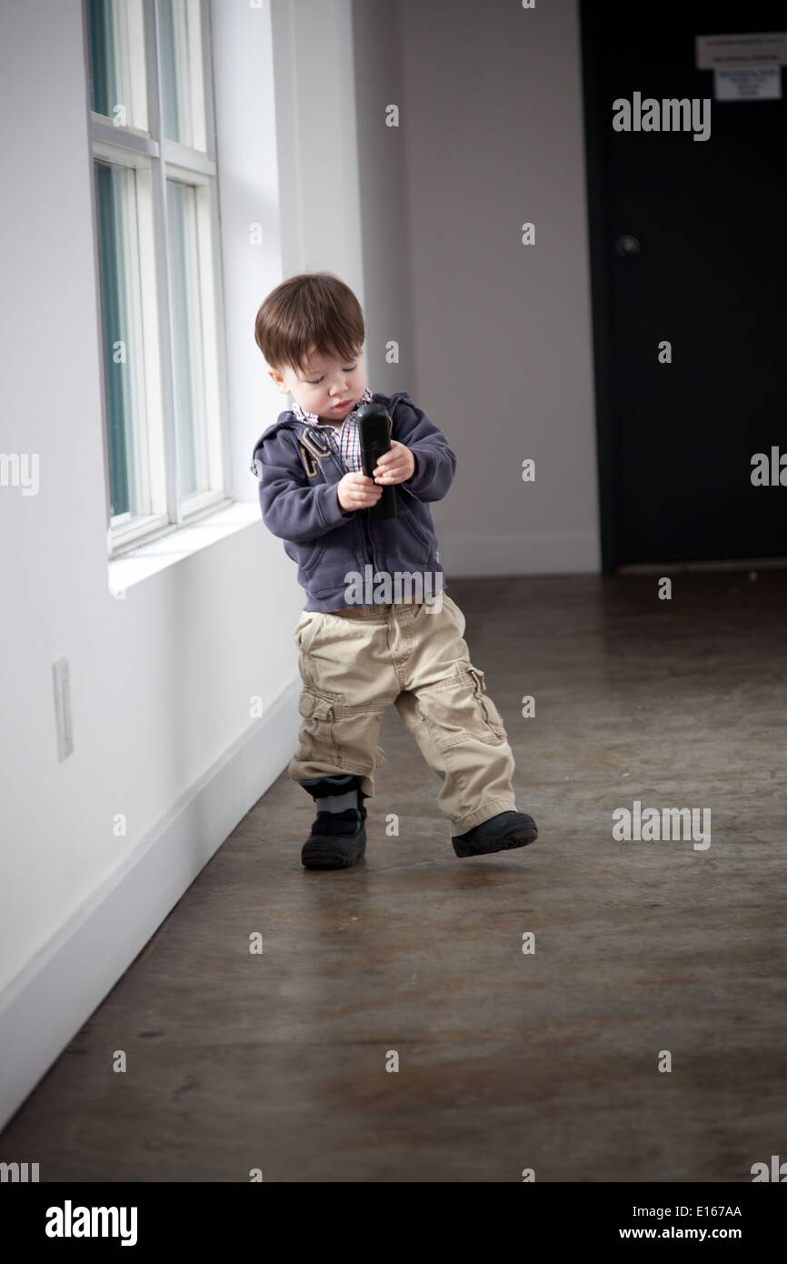 Boy playing with a remote control Stock Photo - Alamy