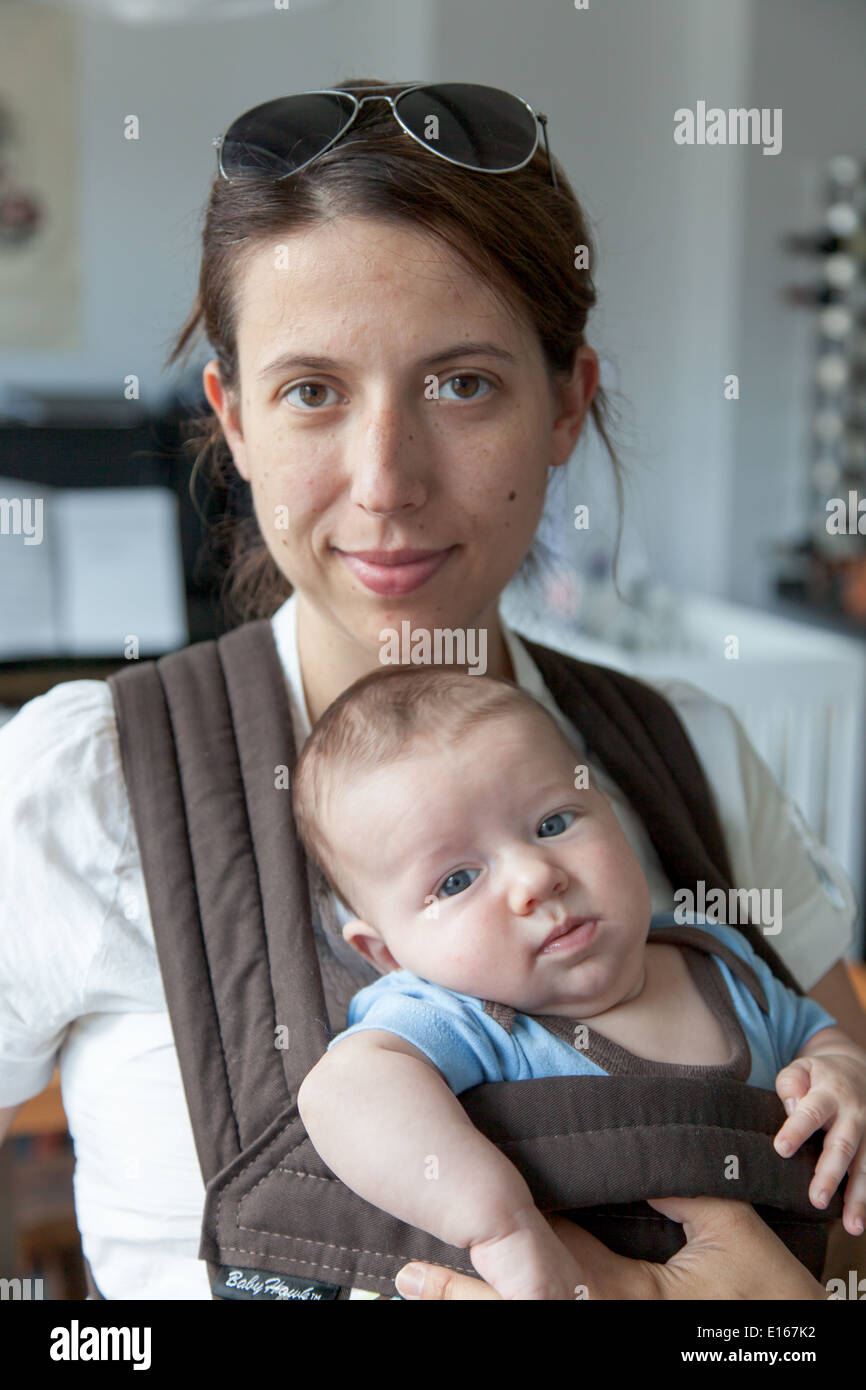 Portrait of a woman carrying her baby boy Stock Photo - Alamy