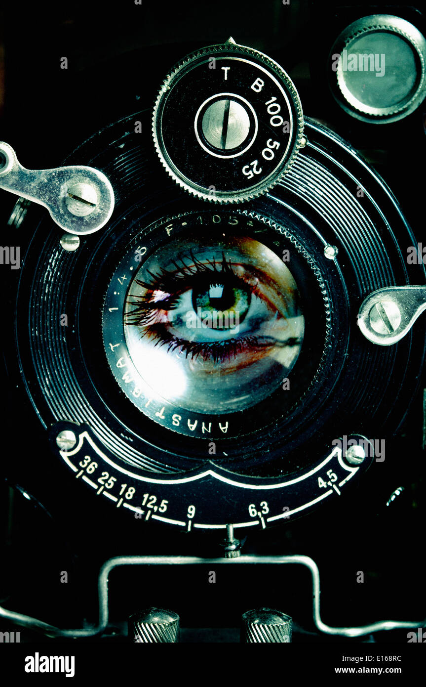 old photo camera with an eye inside the lens Stock Photo - Alamy
