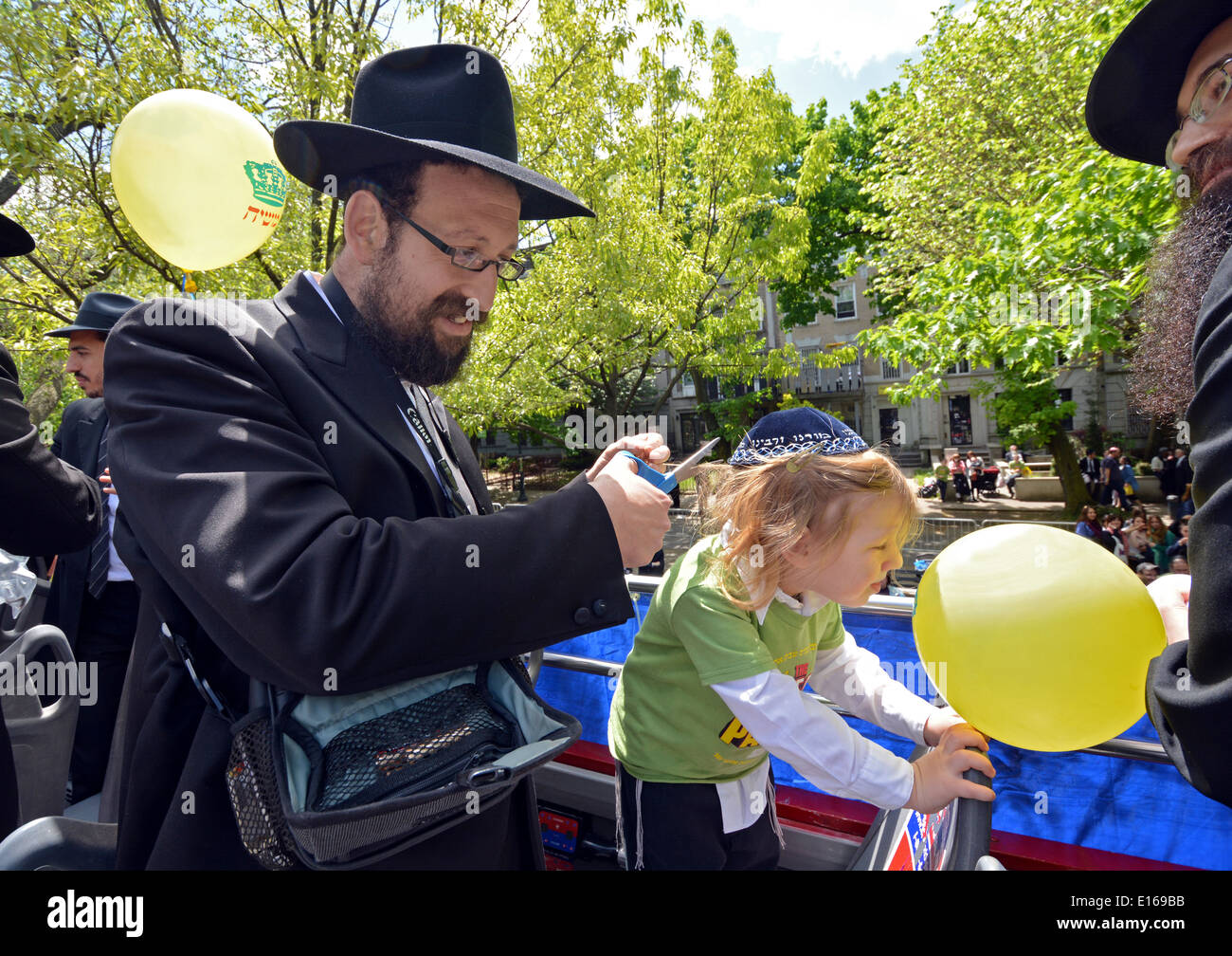 A religious Jewish father giving his son his first haircut at he Lag B ...