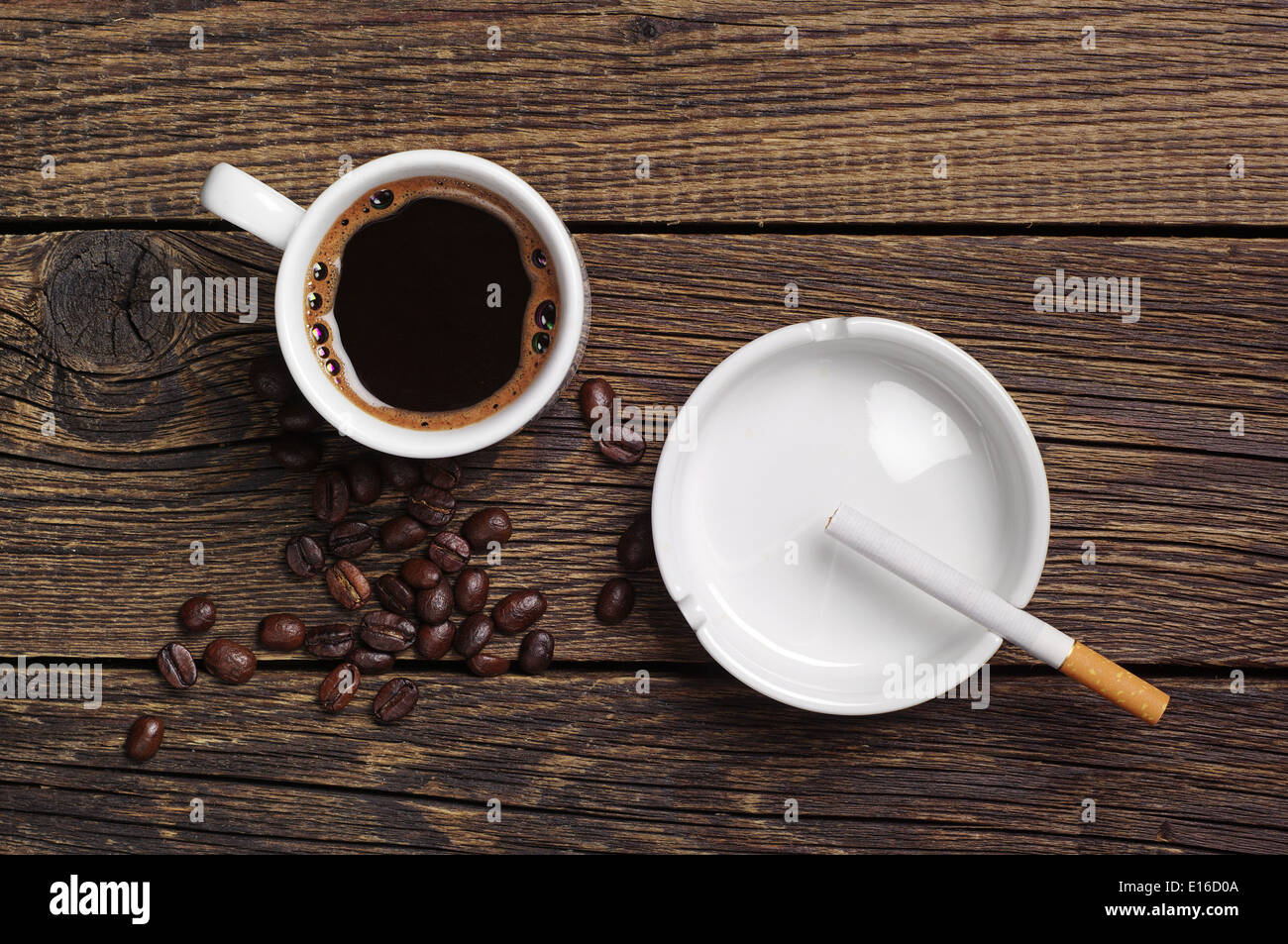 Coffee, ashtray and cigarette on vintage wooden background. Top view ...