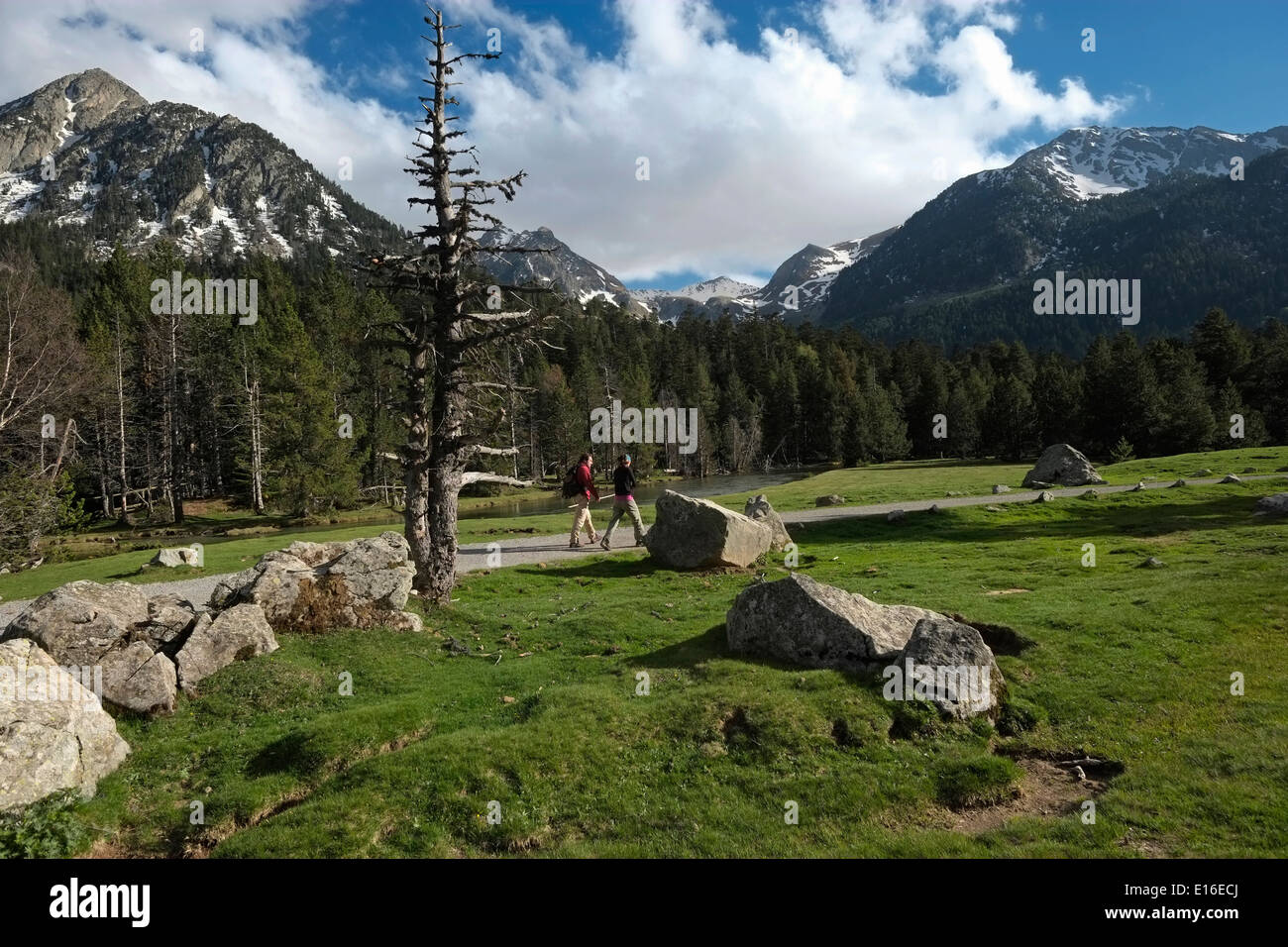 Hikers walk in Parque Nacional d'aiguestortes I Estany de san Maurici ...
