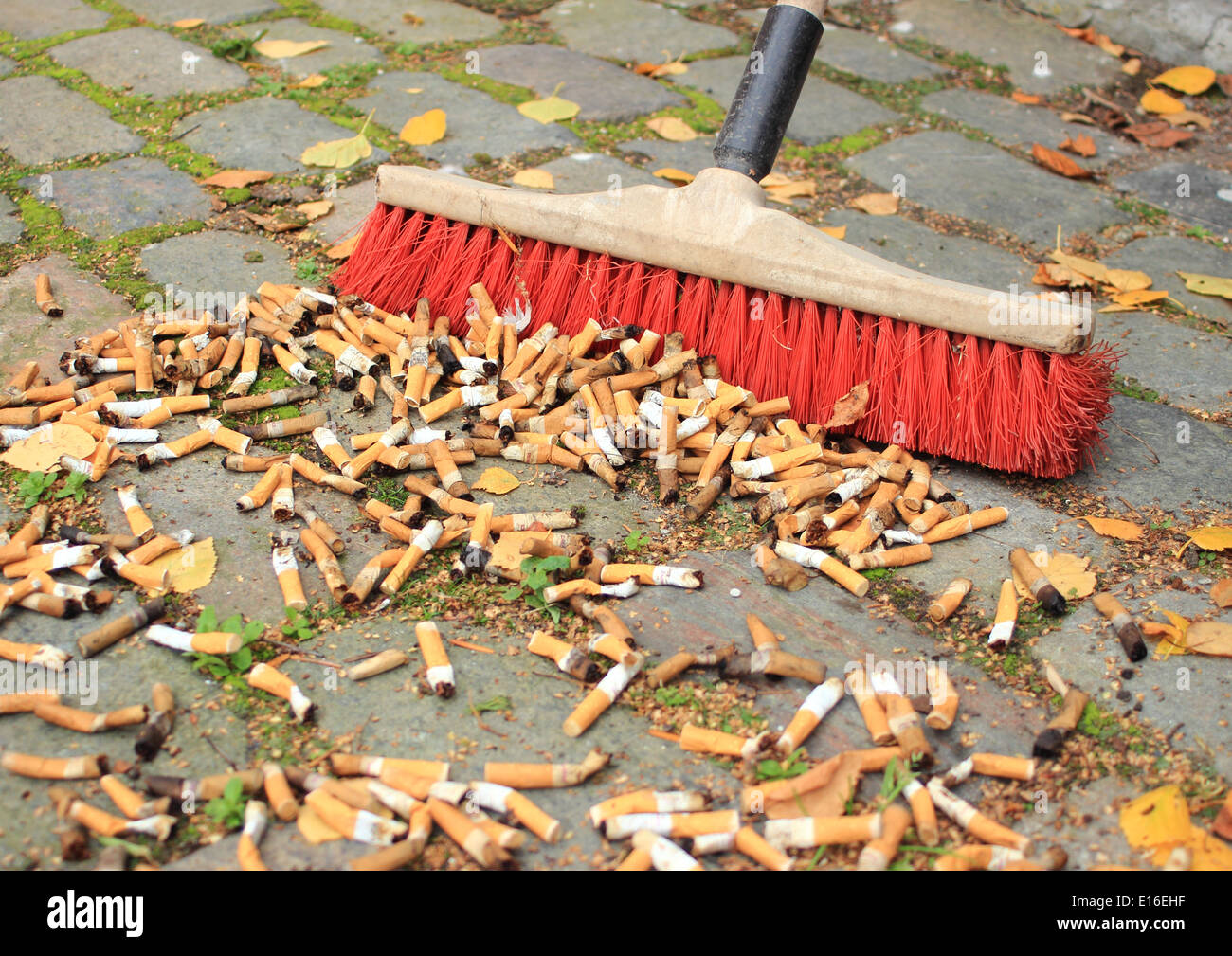 Sweeping a lot of cigarette butts from stone road Stock Photo - Alamy