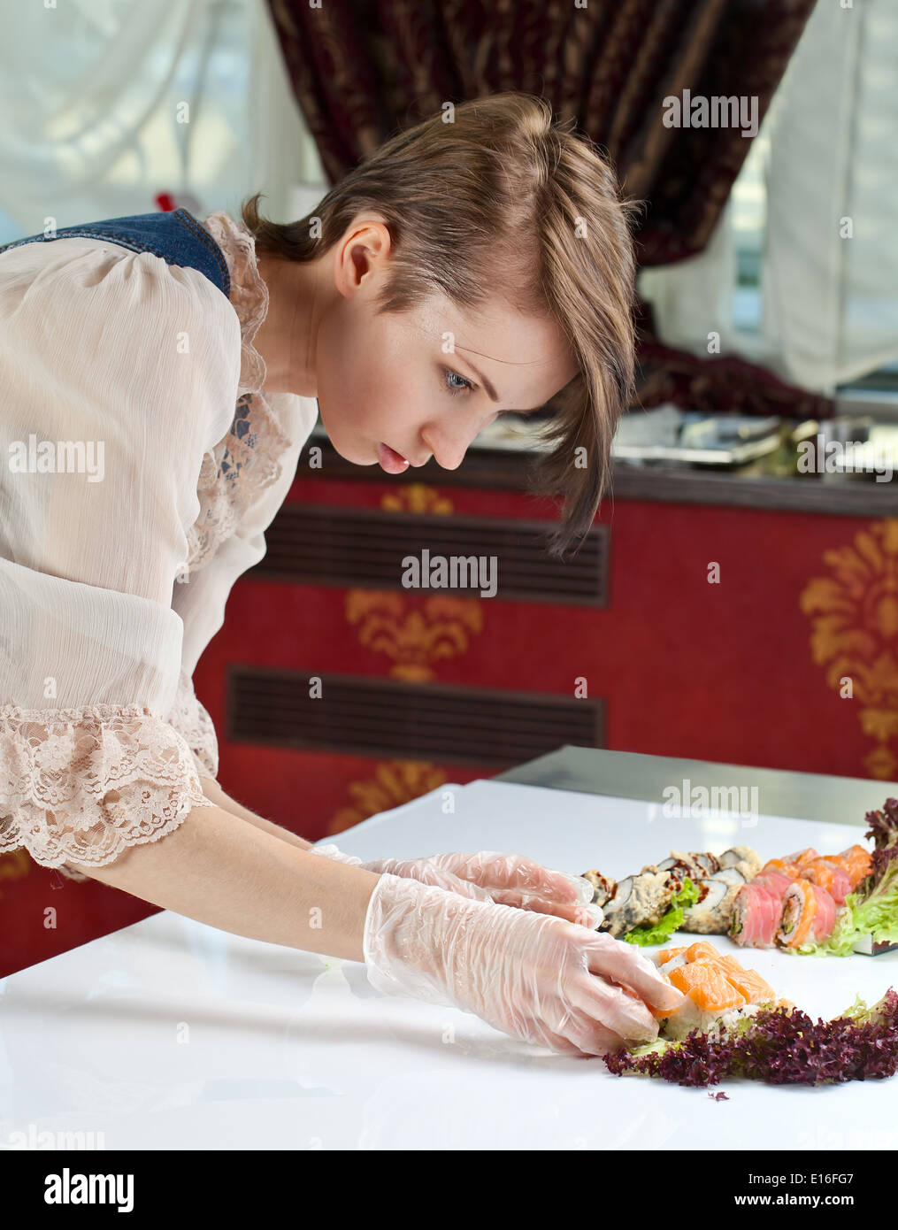 The young woman lays the table with seafood Stock Photo - Alamy