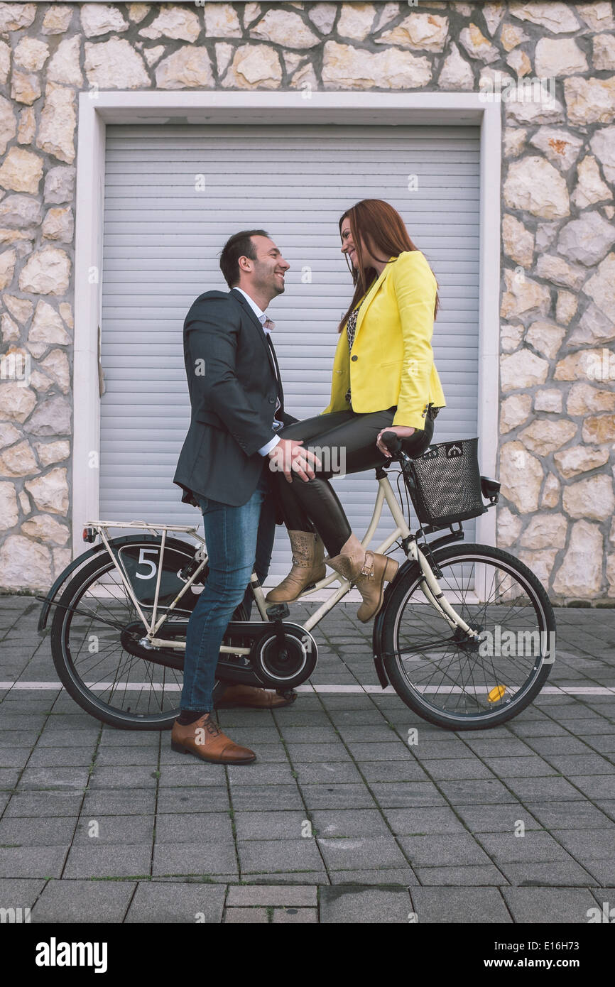 Happy couple on a bike Stock Photo - Alamy
