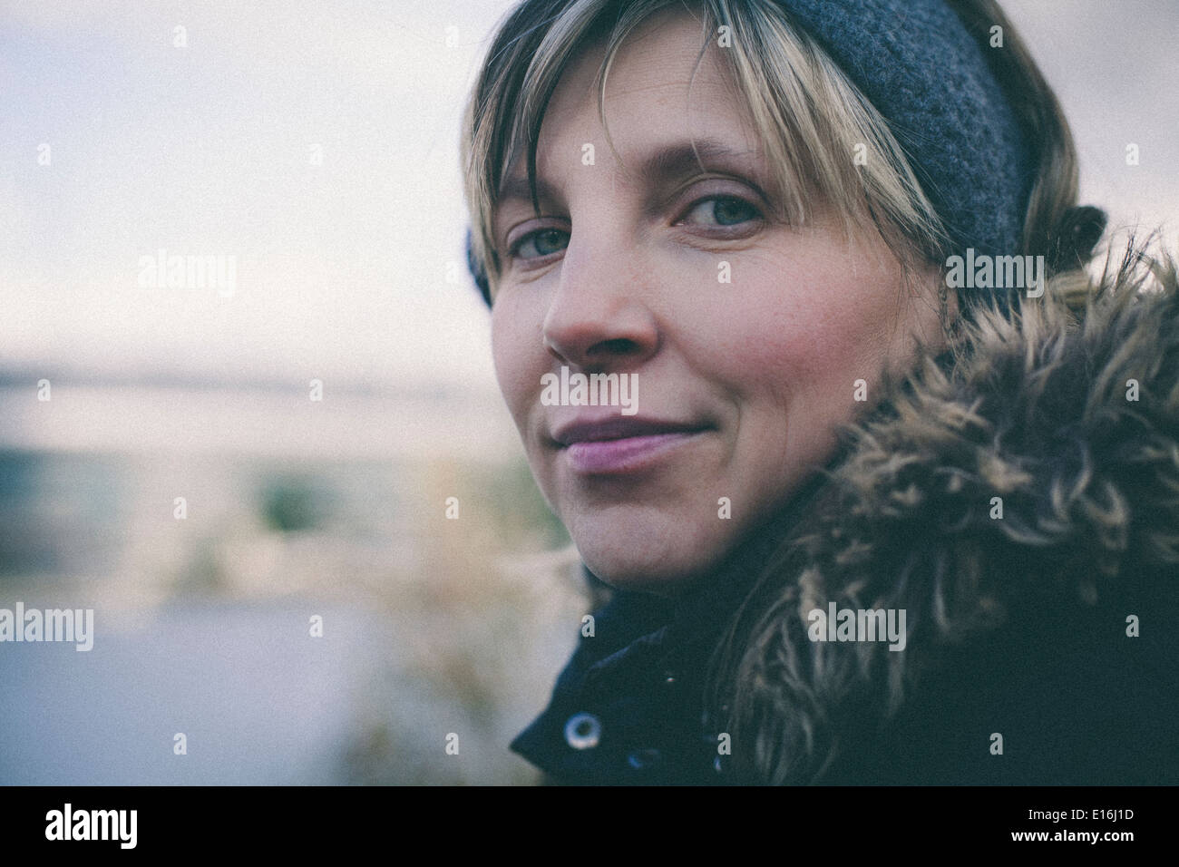 Mid adult woman looking at camera Stock Photo - Alamy