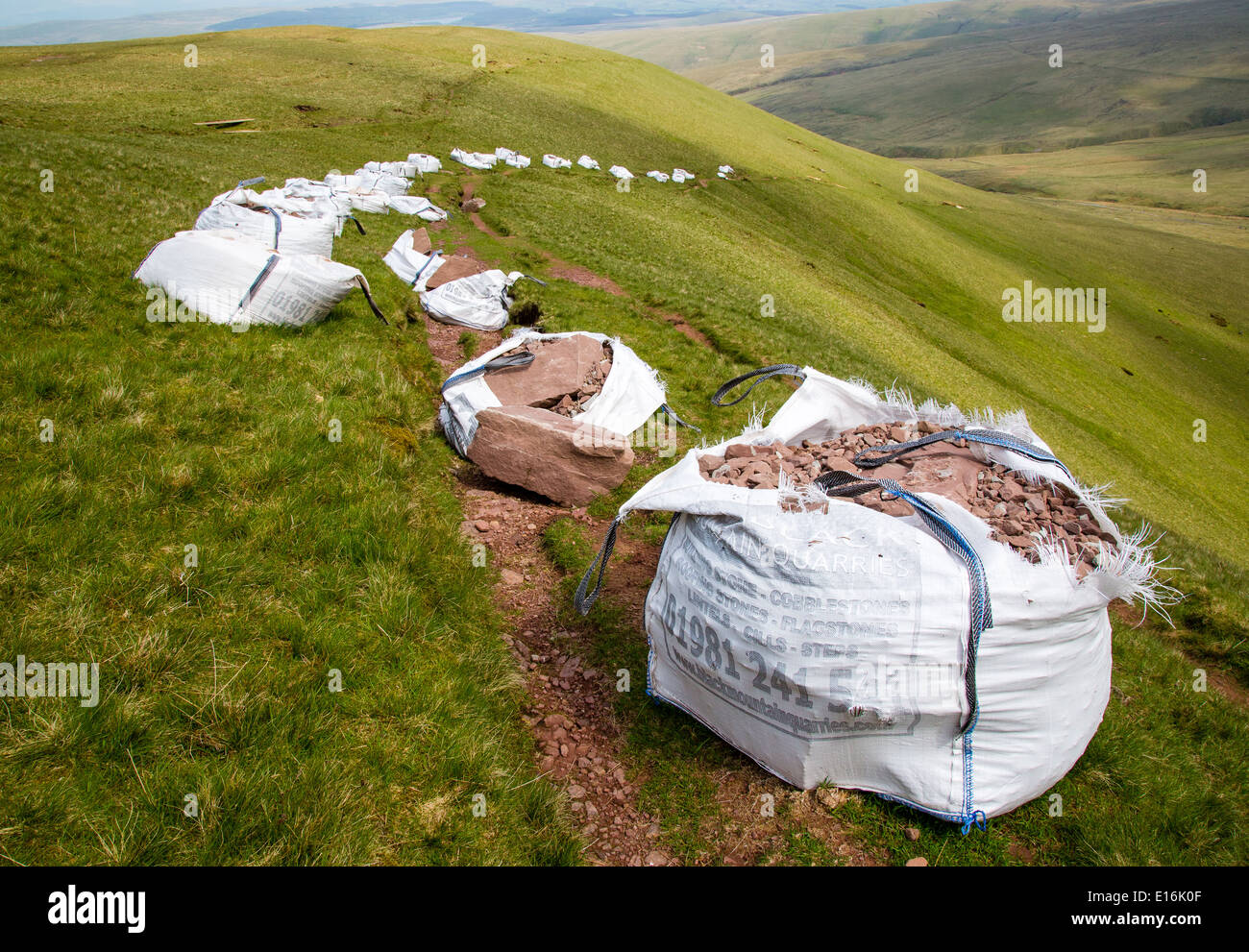 Bags of building materials used to construct a solid footpath along the ...