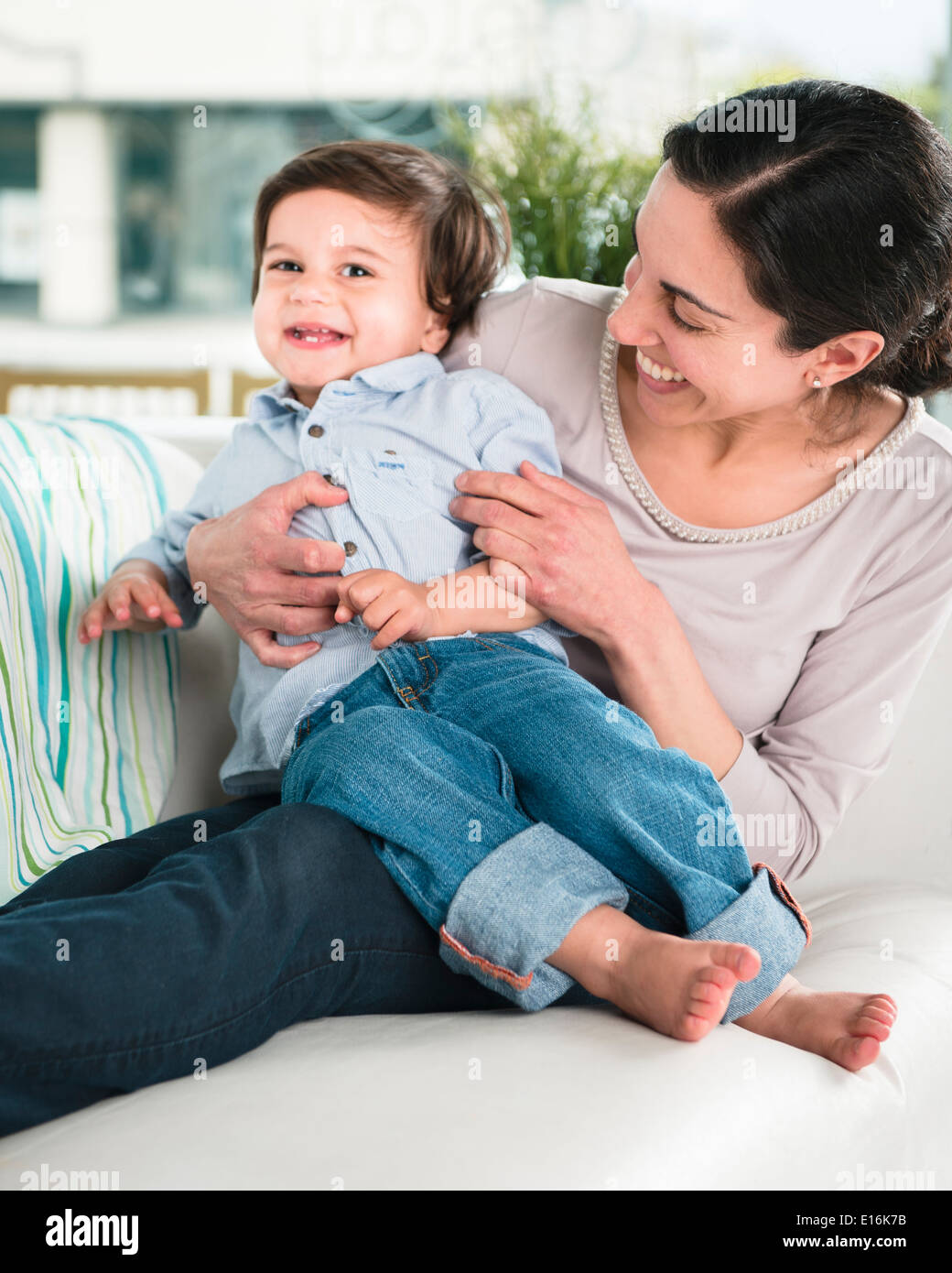 Mother tickling his baby son (12-23 months Stock Photo - Alamy