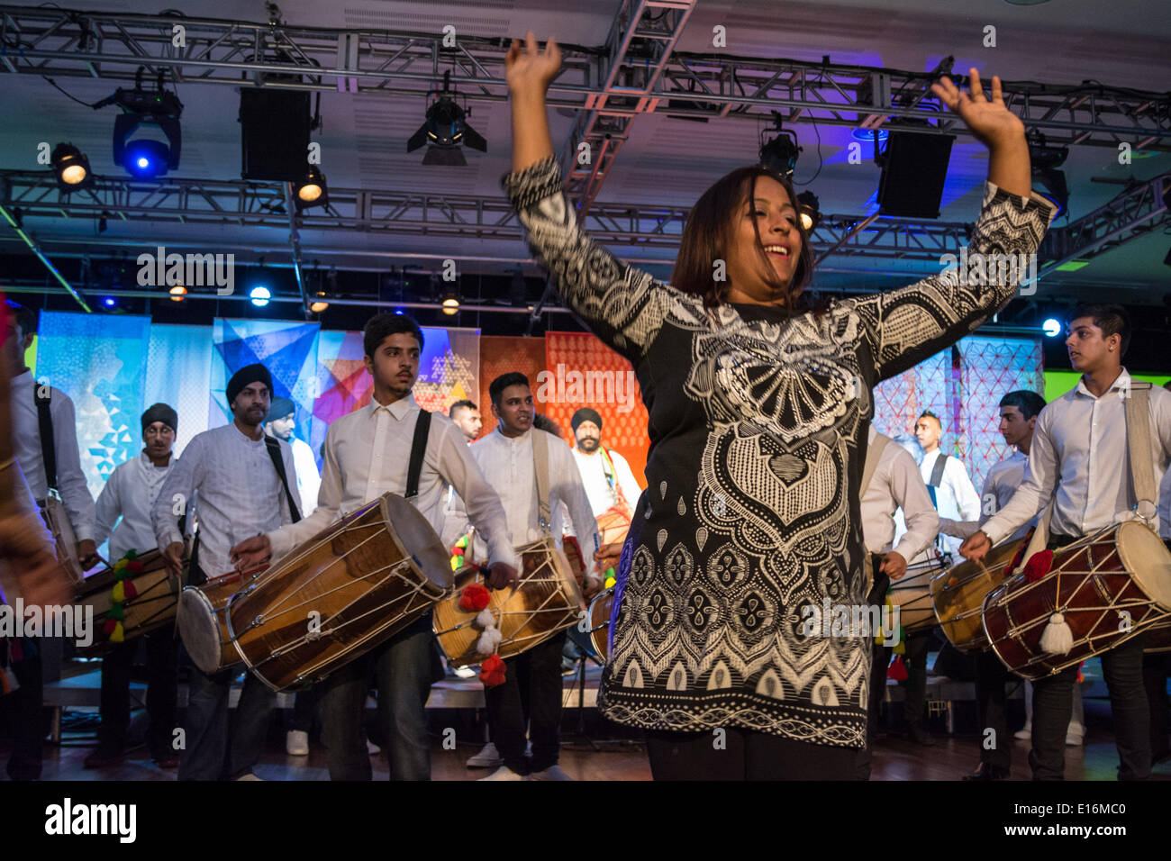 A woman dances as Dhol drummers play traditional North Indian rhythms ...