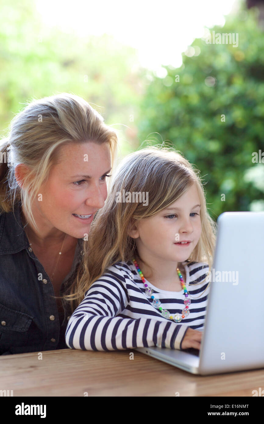 Mother and daughter using laptop Stock Photo - Alamy