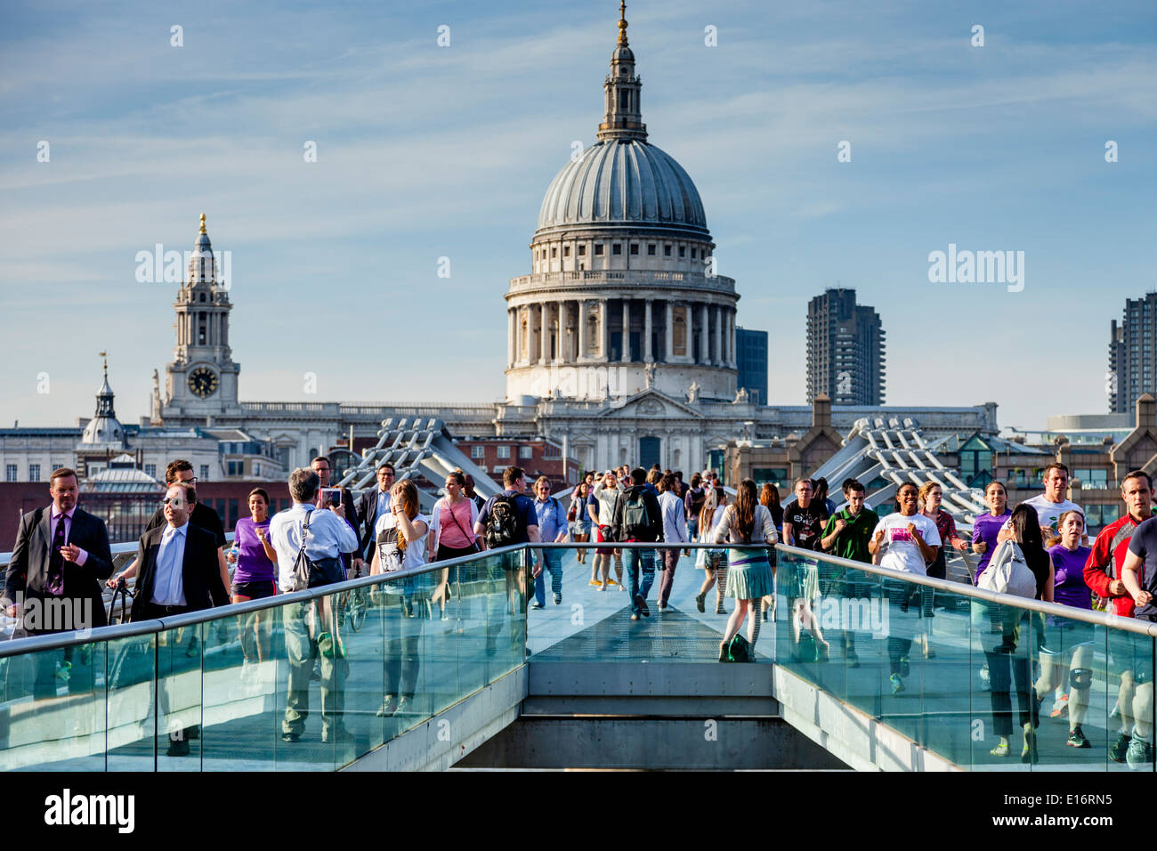 People Walking Across The Millennium Bridge, London, England Stock ...