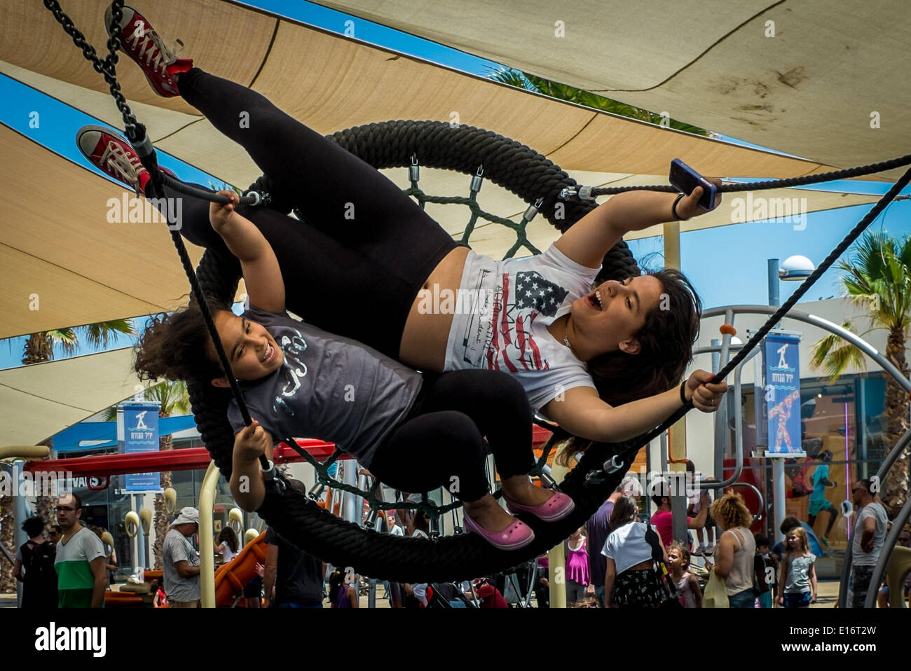 Tel Aviv, Israel. 24th May, 2014. Israeli girls have fun on a swing at ...