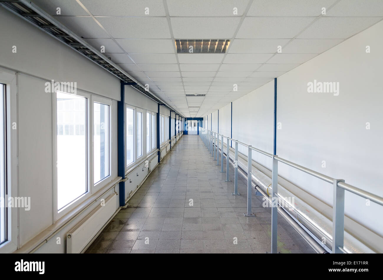 Long corridor with door at end Stock Photo - Alamy
