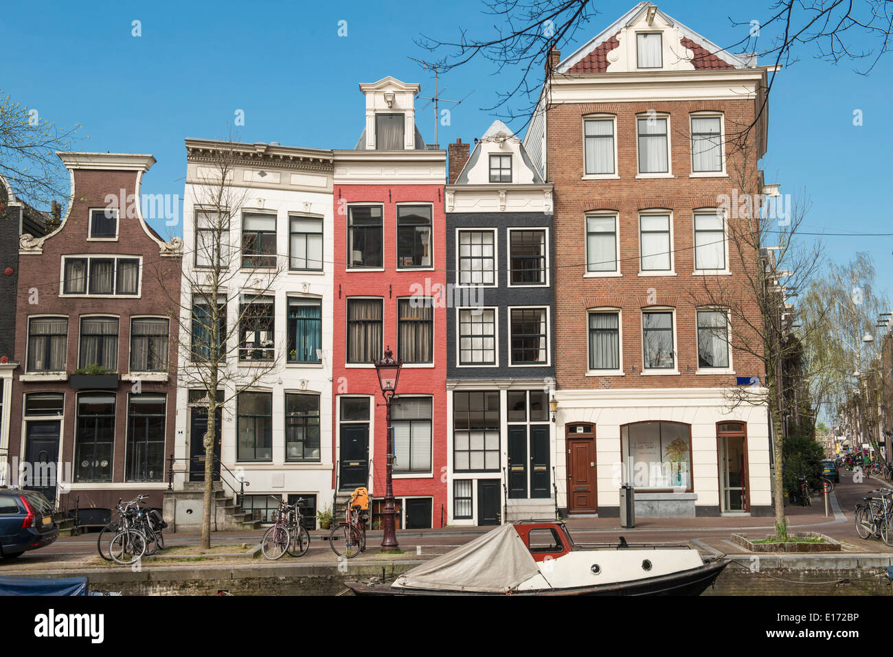 The typical Dutch houses on a blue spring day Amsterdam, Netherlands ...