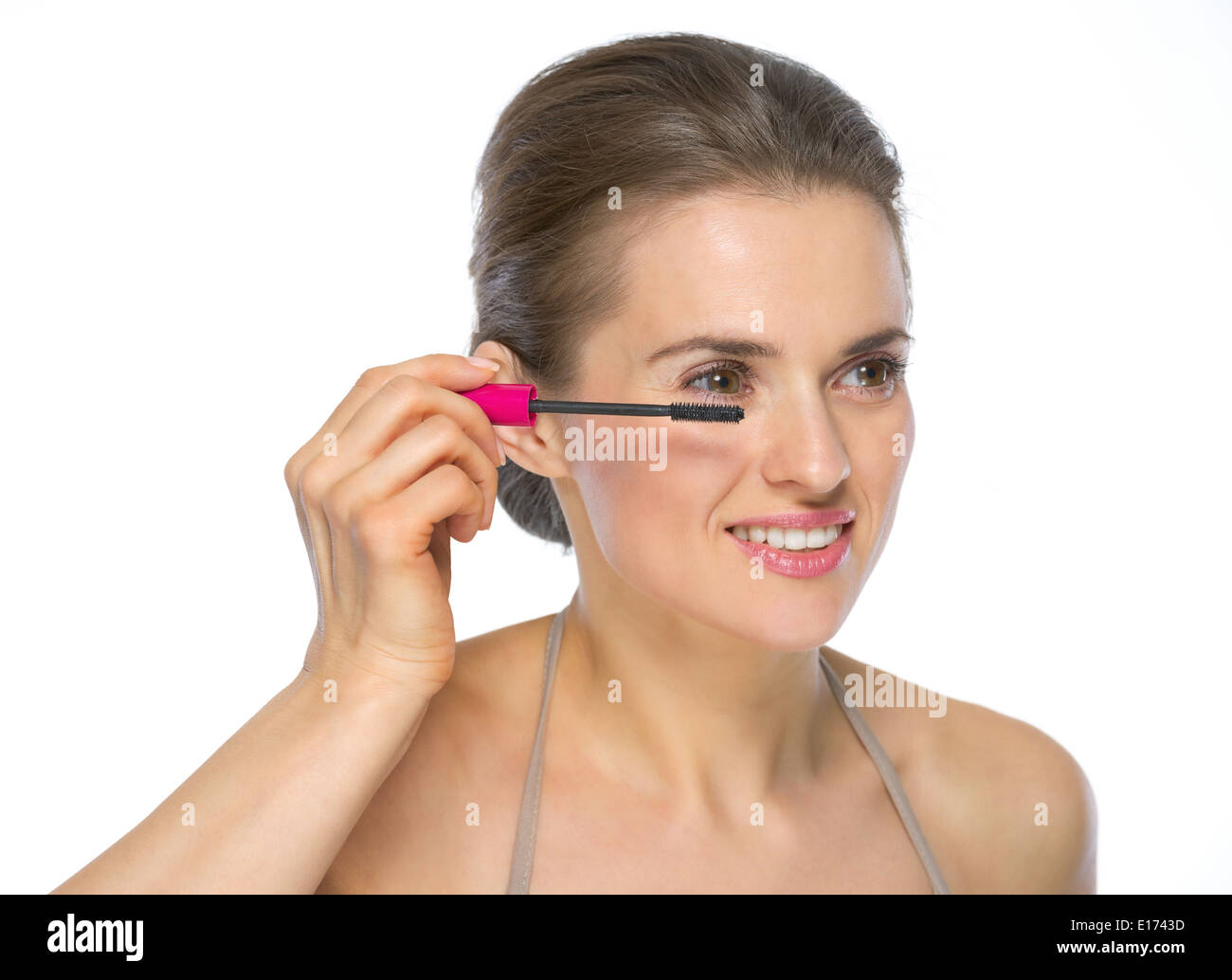 Happy young woman applying mascara Stock Photo - Alamy