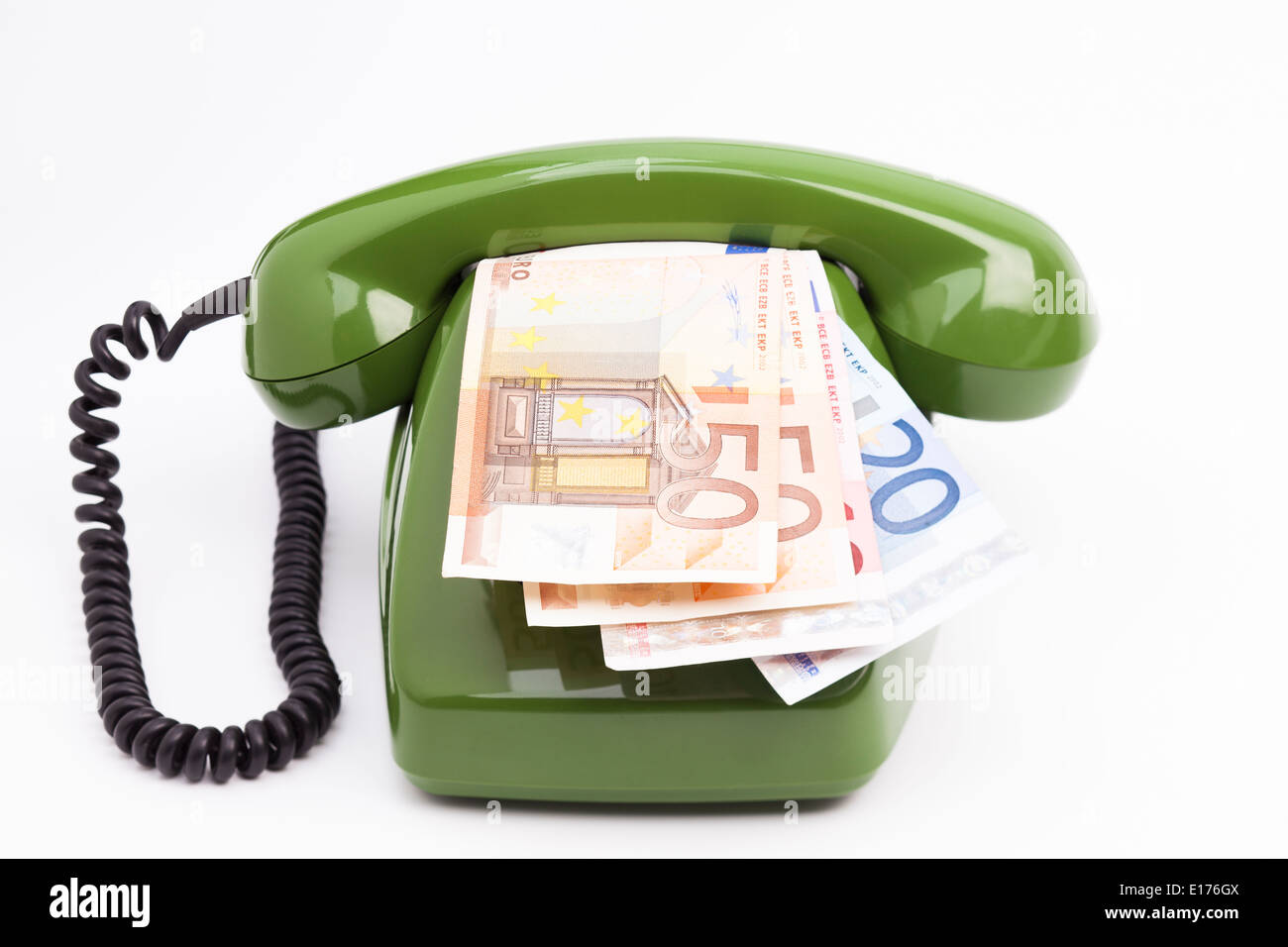 Image shows a green retro telephone isolated on a white background ...