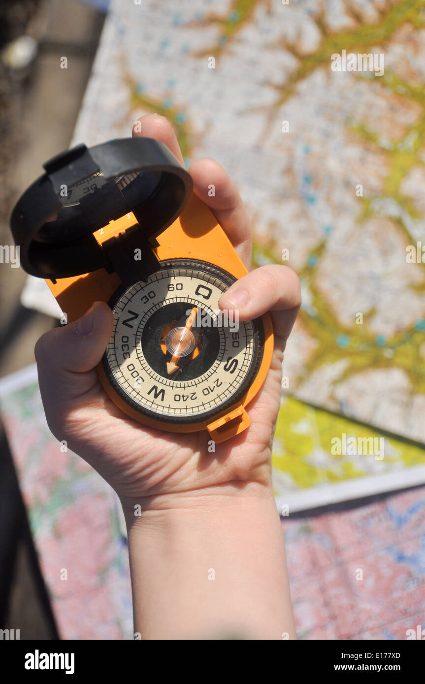 Equipment for orientation on terrain. The compass in his hand on the ...