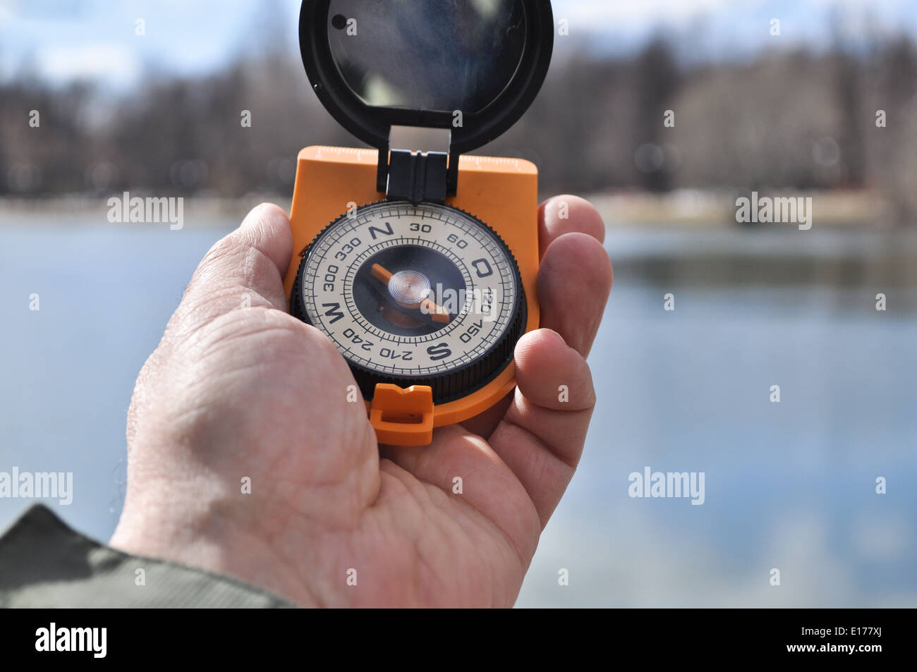 Man holds in his hand the magnetic compass, not to get lost away from ...