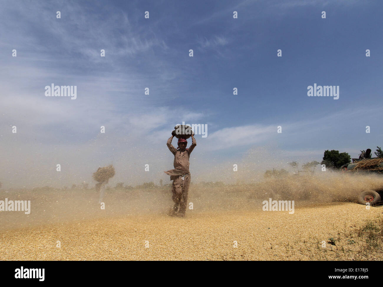 LAHORE, PAKISTAN-MAY 25: Pakistani Farmers works on wheat threshers at ...