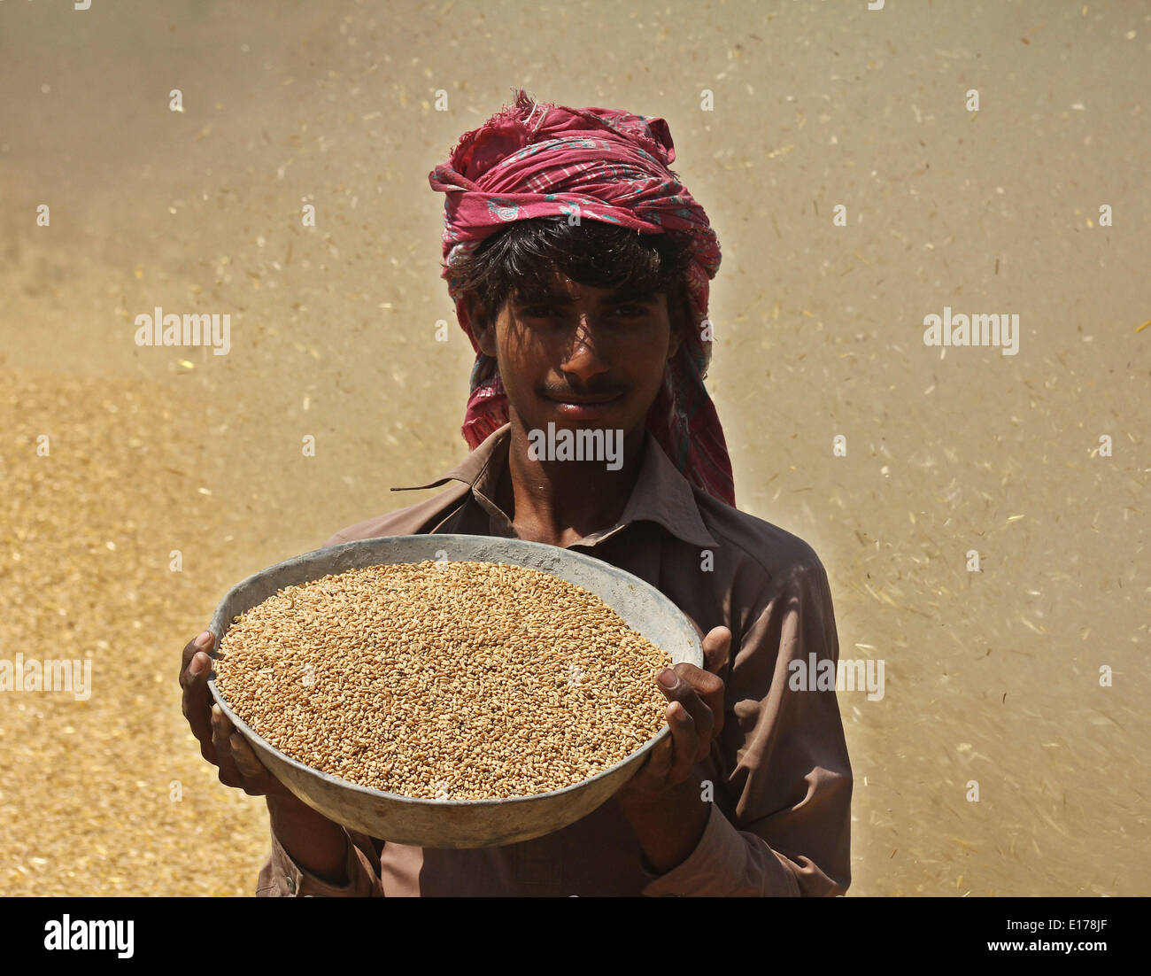 LAHORE, PAKISTAN-MAY 25: Pakistani Farmers works on wheat threshers at ...