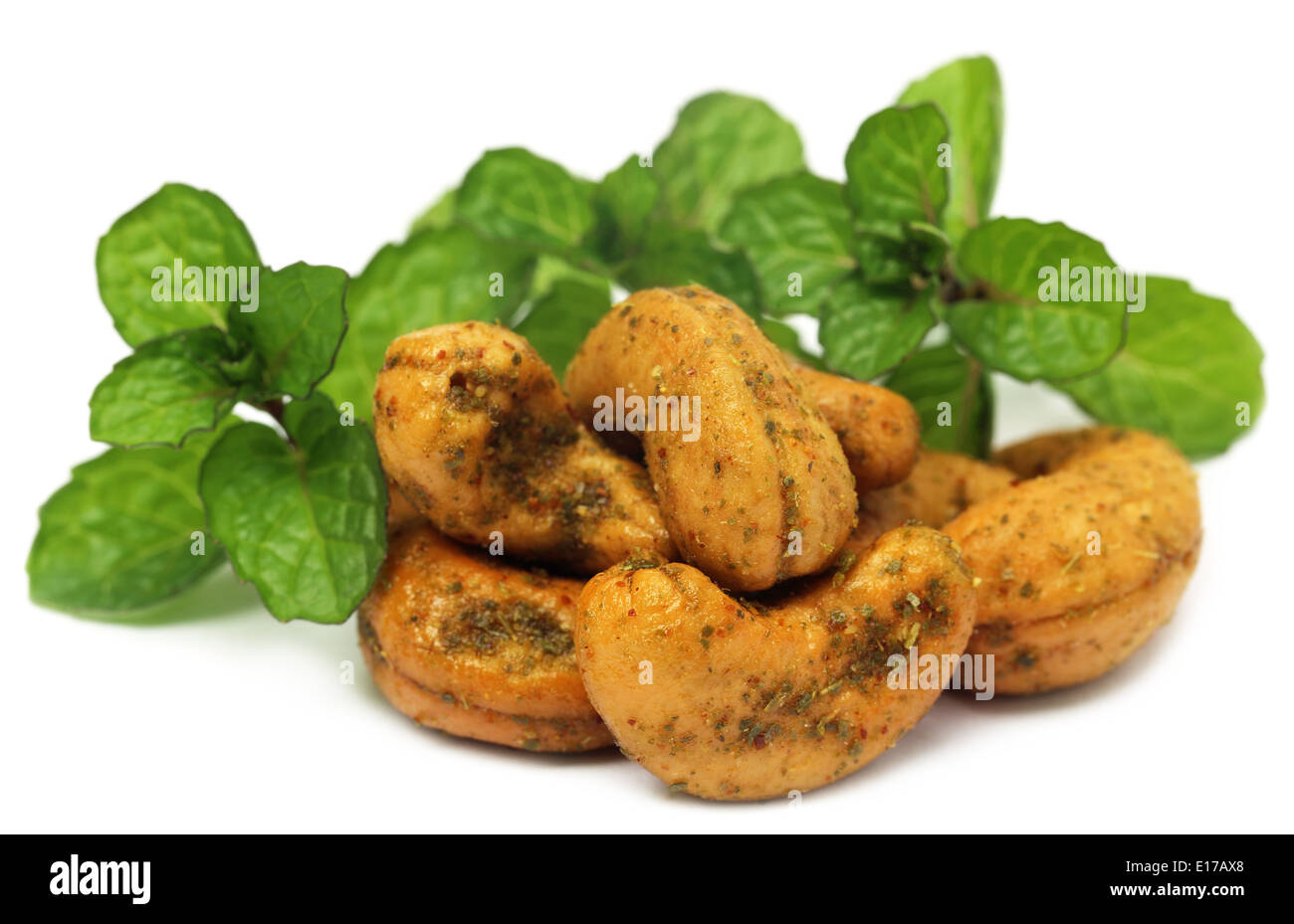 Cashew nuts with green mint leaves over white background Stock Photo ...