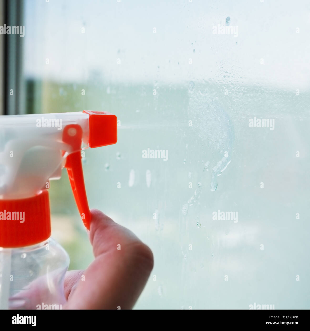 washing home window - liquid jet from spray bottle on glass Stock Photo ...