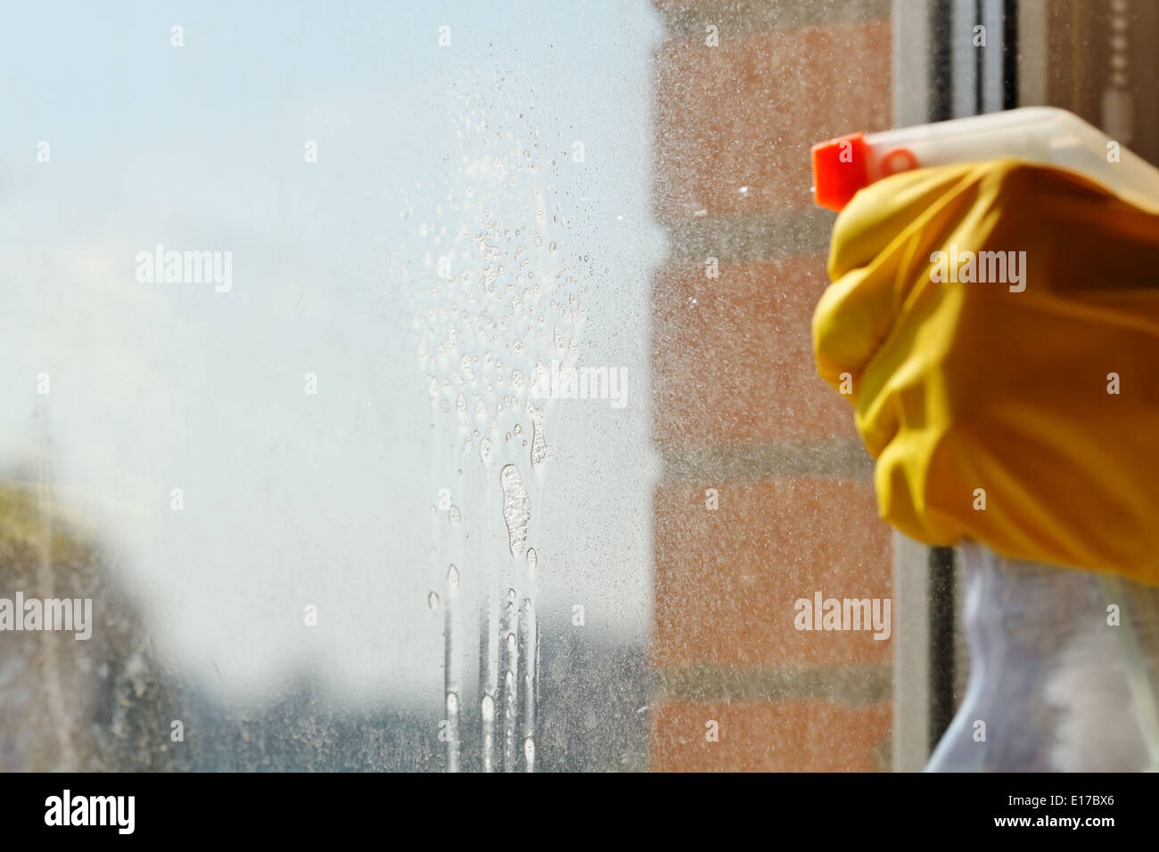 washing window glass - detergent jet from spray bottle Stock Photo - Alamy