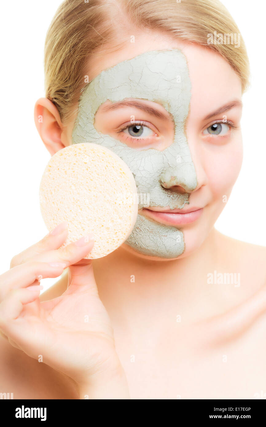 Skin care. Woman removing clay mud facial mask Stock Photo - Alamy